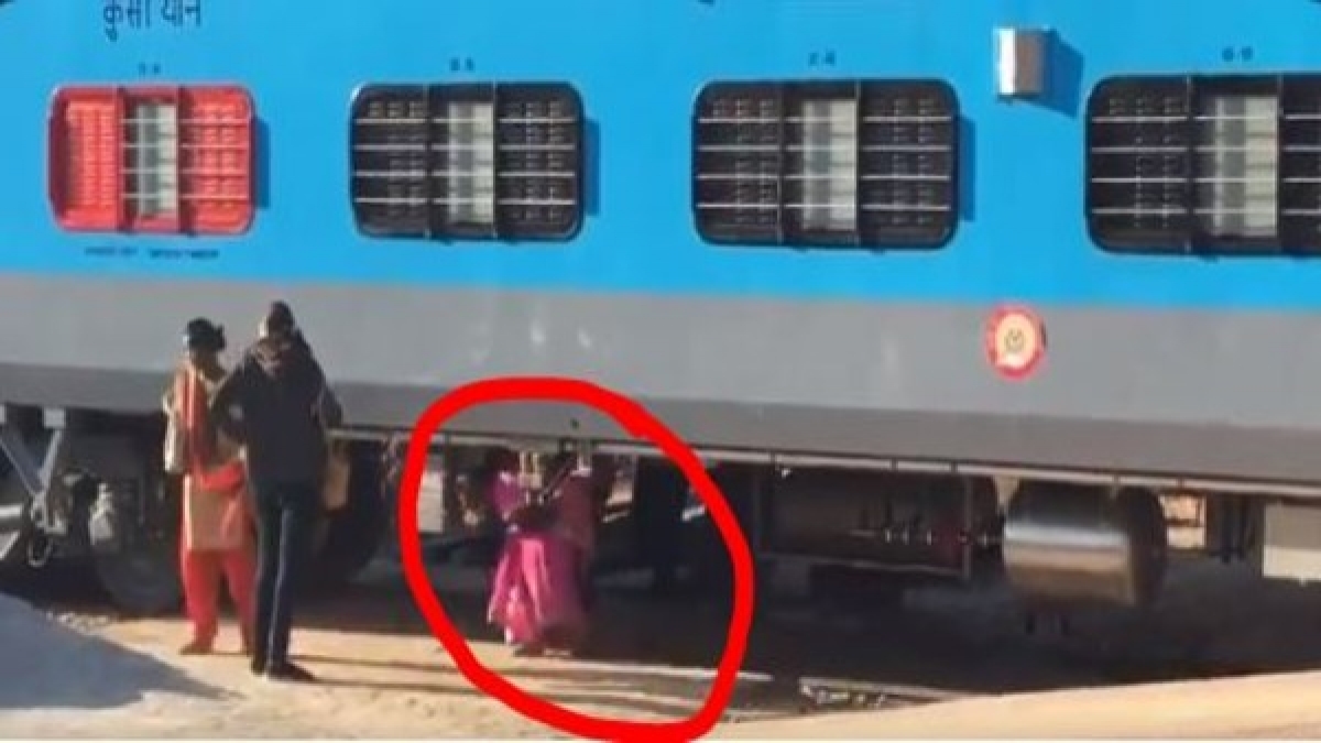 Commuters slide under the train at Whitefield to cross the track, see ...