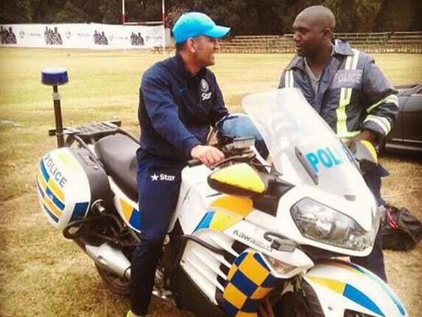 MS Dhoni spotted riding policeman bike in Zimbabwe after match - Oneindia