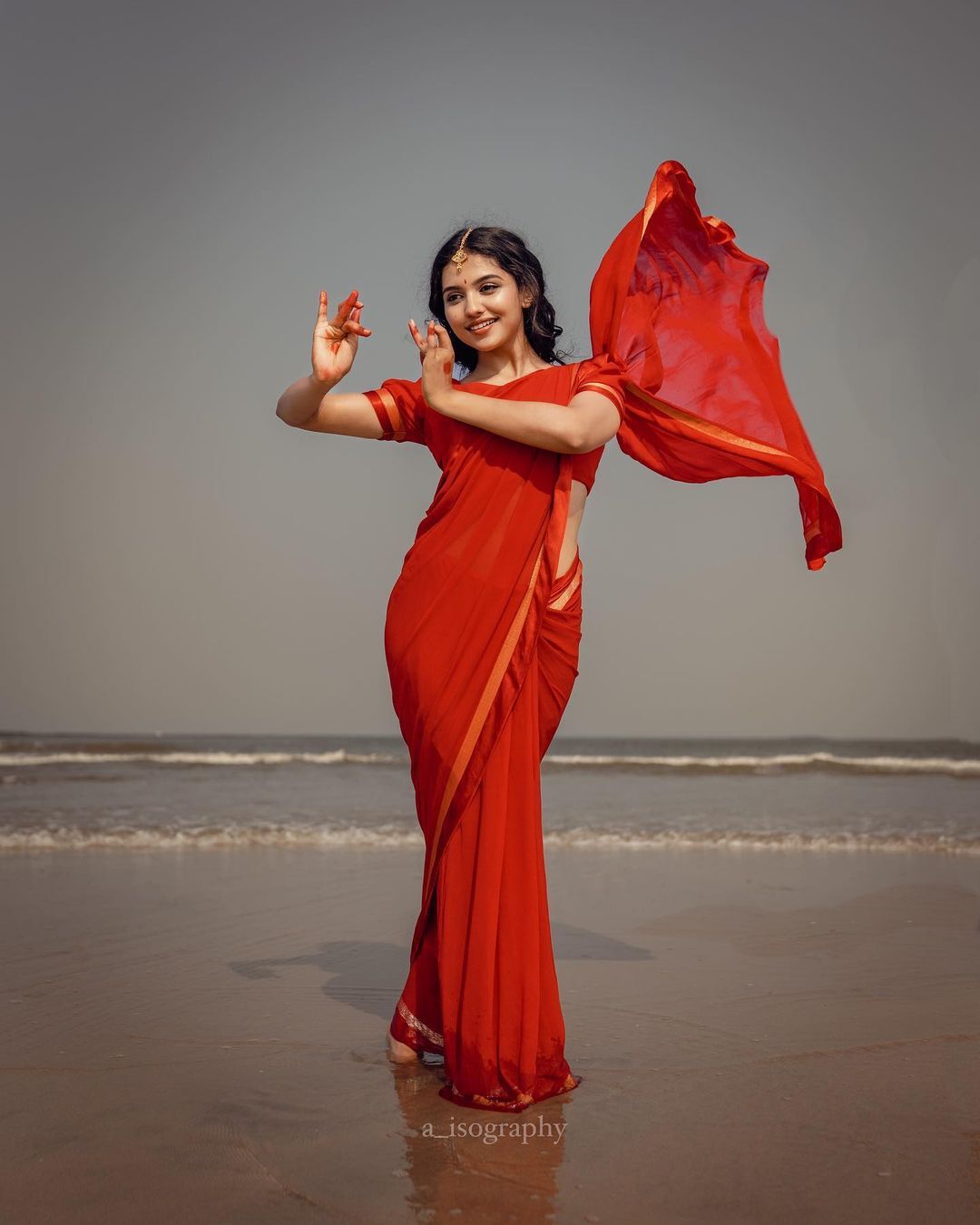 Actress Mamitha Baiju Looks Stunning in Red Sareee in Beach Side Clicks ...