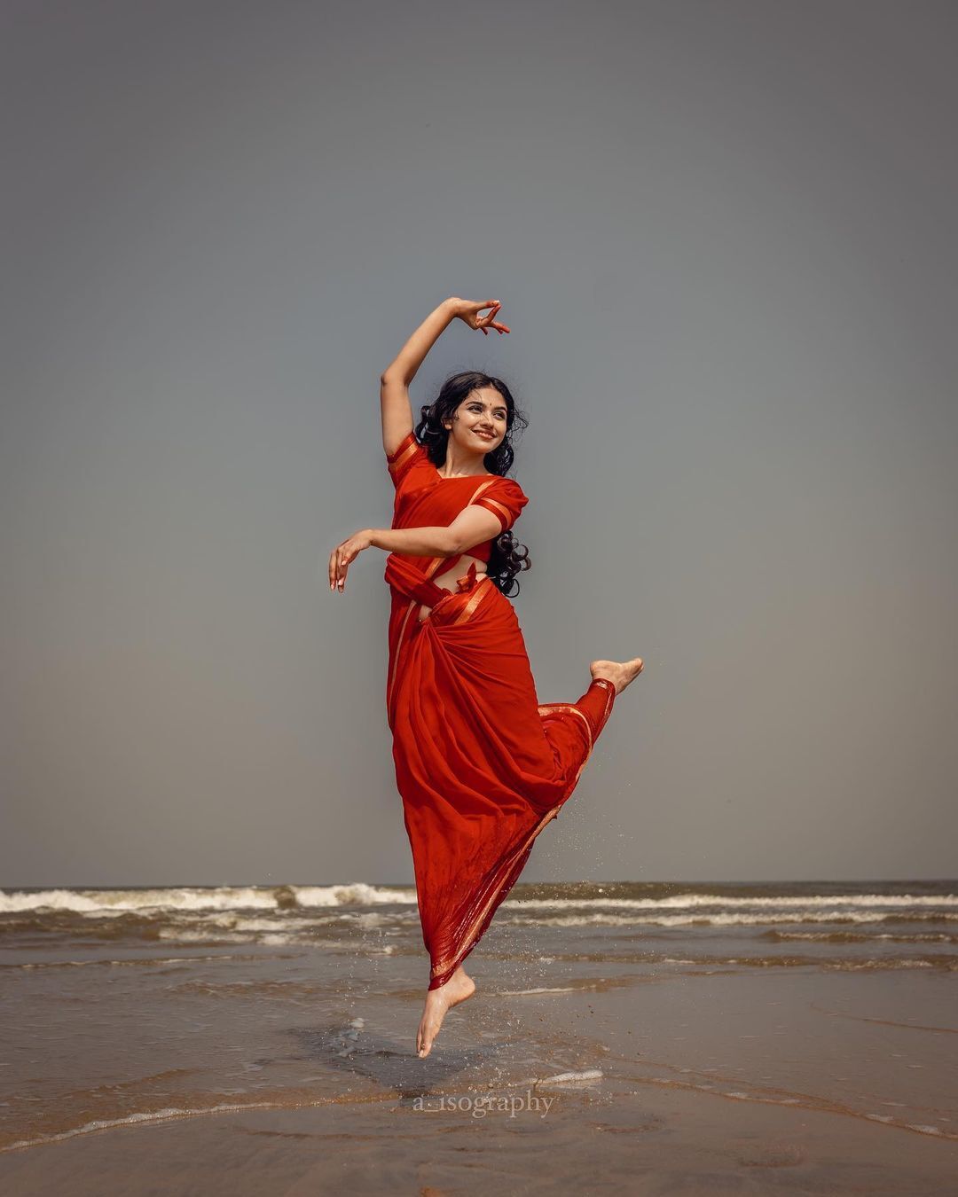 Actress Mamitha Baiju Looks Stunning in Red Sareee in Beach Side Clicks ...
